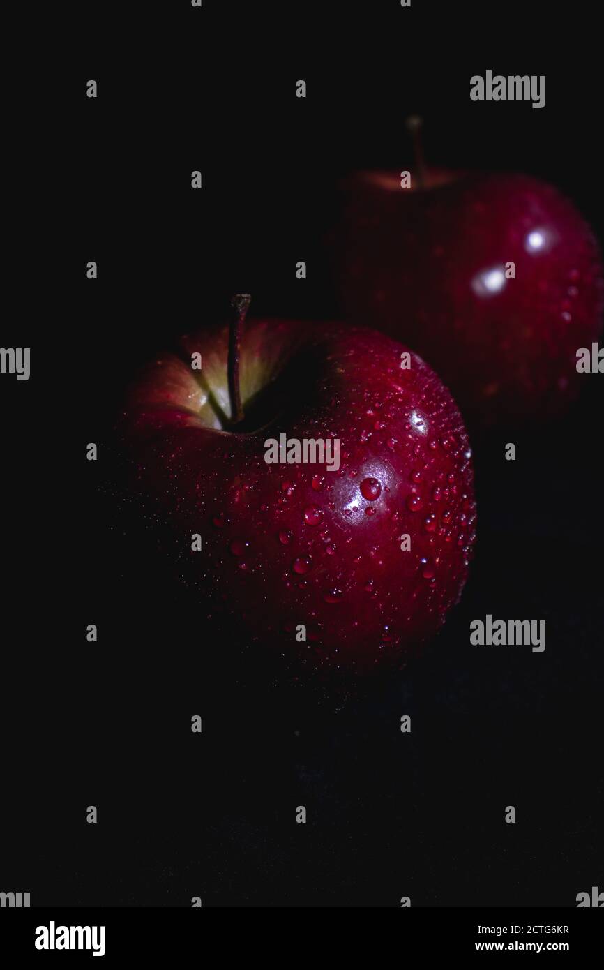 Apple fruit, abstract shadow, black background, red apple, drops of ...