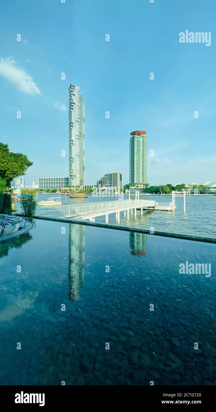 Riverside towers reflected in water Stock Photo - Alamy