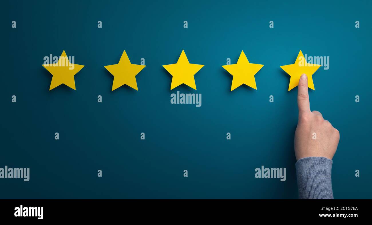 Woman hand point at five star rating on green background Stock Photo ...