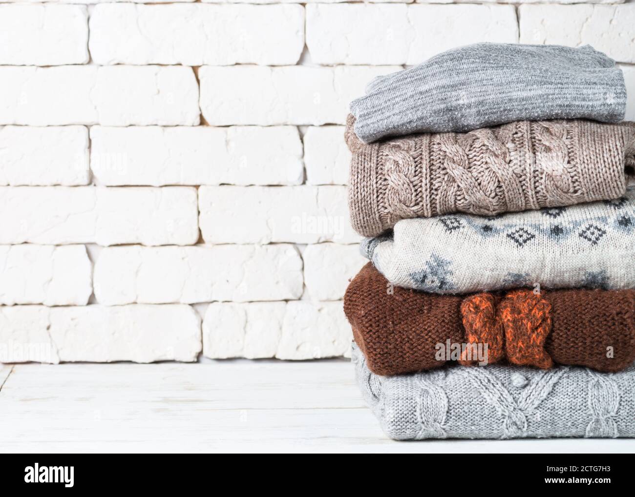 Stack of cozy woolen clothes on white Stock Photo - Alamy