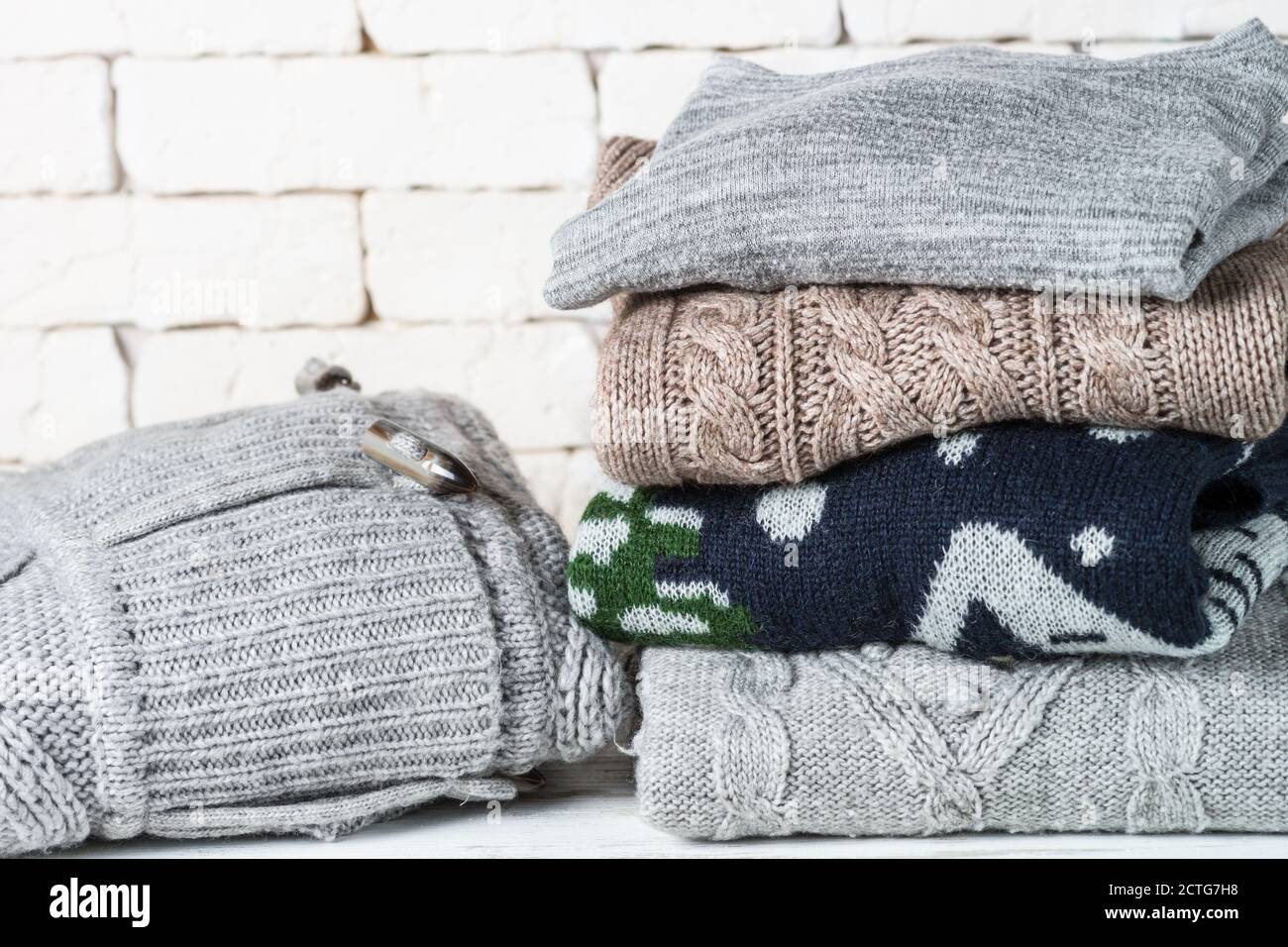 Stack of cozy woolen clothes on white Stock Photo - Alamy