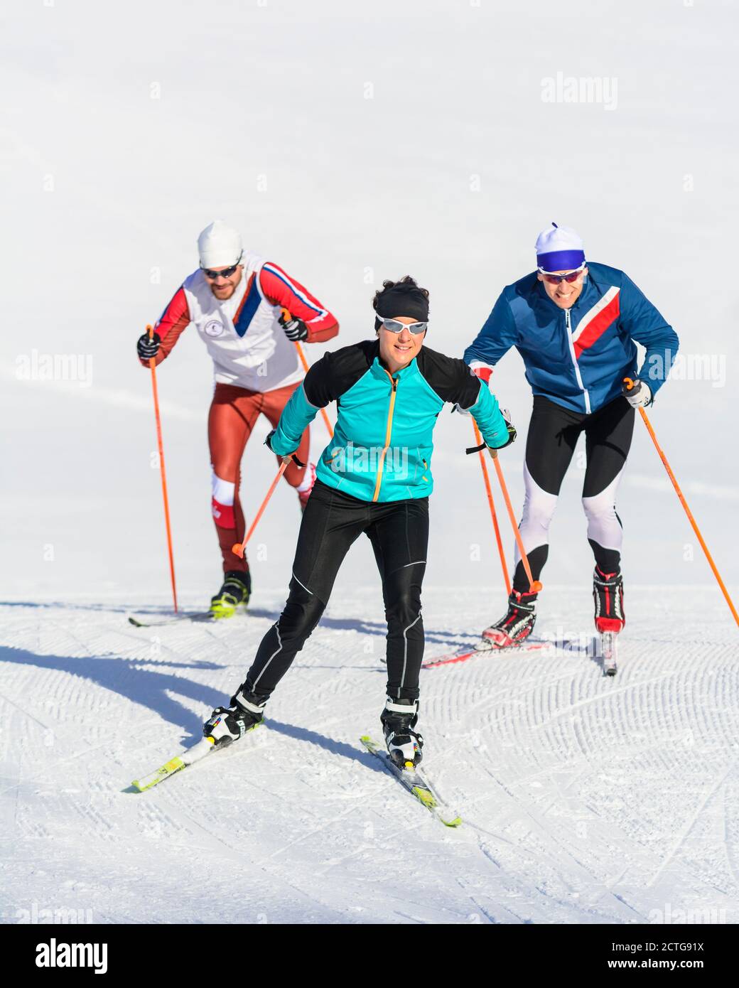 Three young athletes doing skating session on wintry slope Stock Photo ...