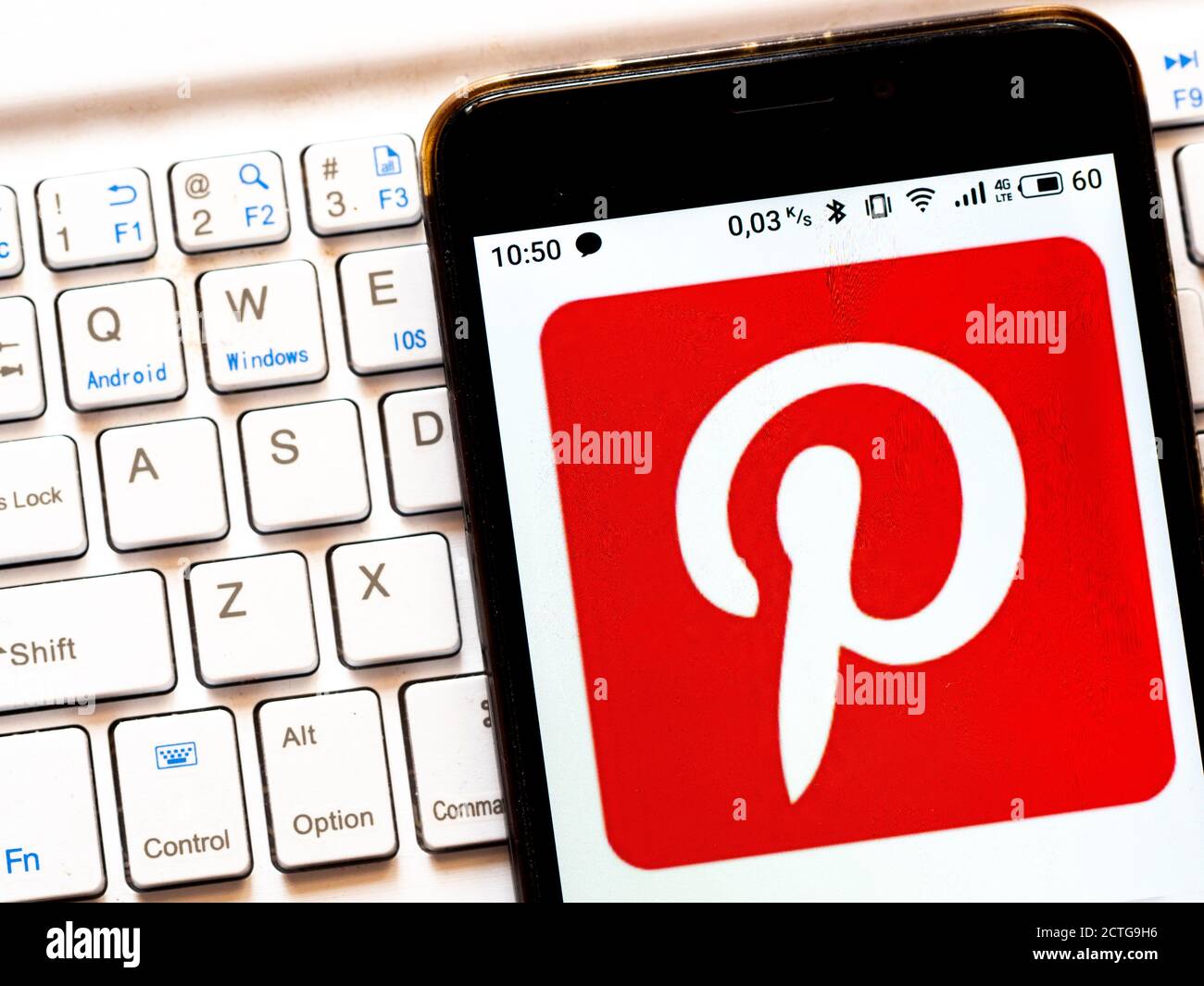 In this photo illustration a Pinterest logo is seen displayed on a ...
