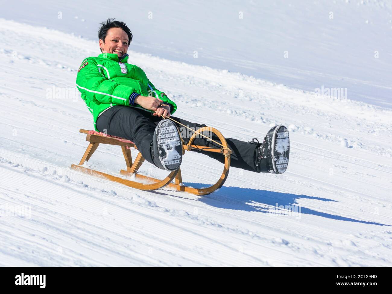 Girl on sleigh in snow hi-res stock photography and images - Alamy