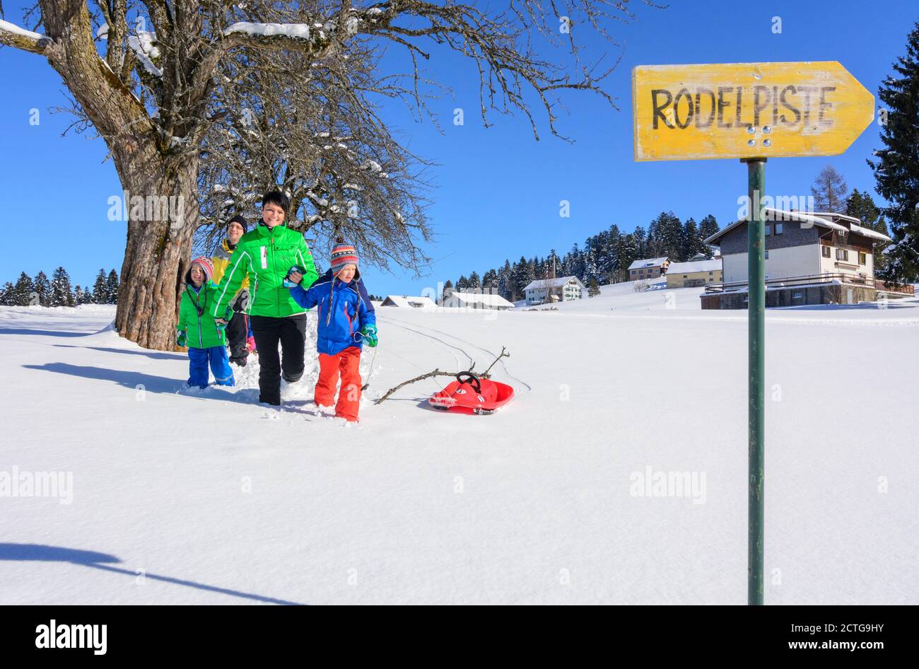 Family ascending to the next sleigh run Stock Photo - Alamy