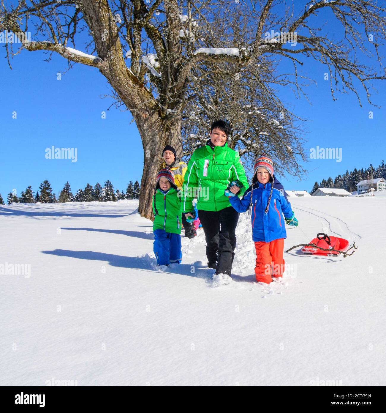 Family ascending to the next sleigh run Stock Photo - Alamy