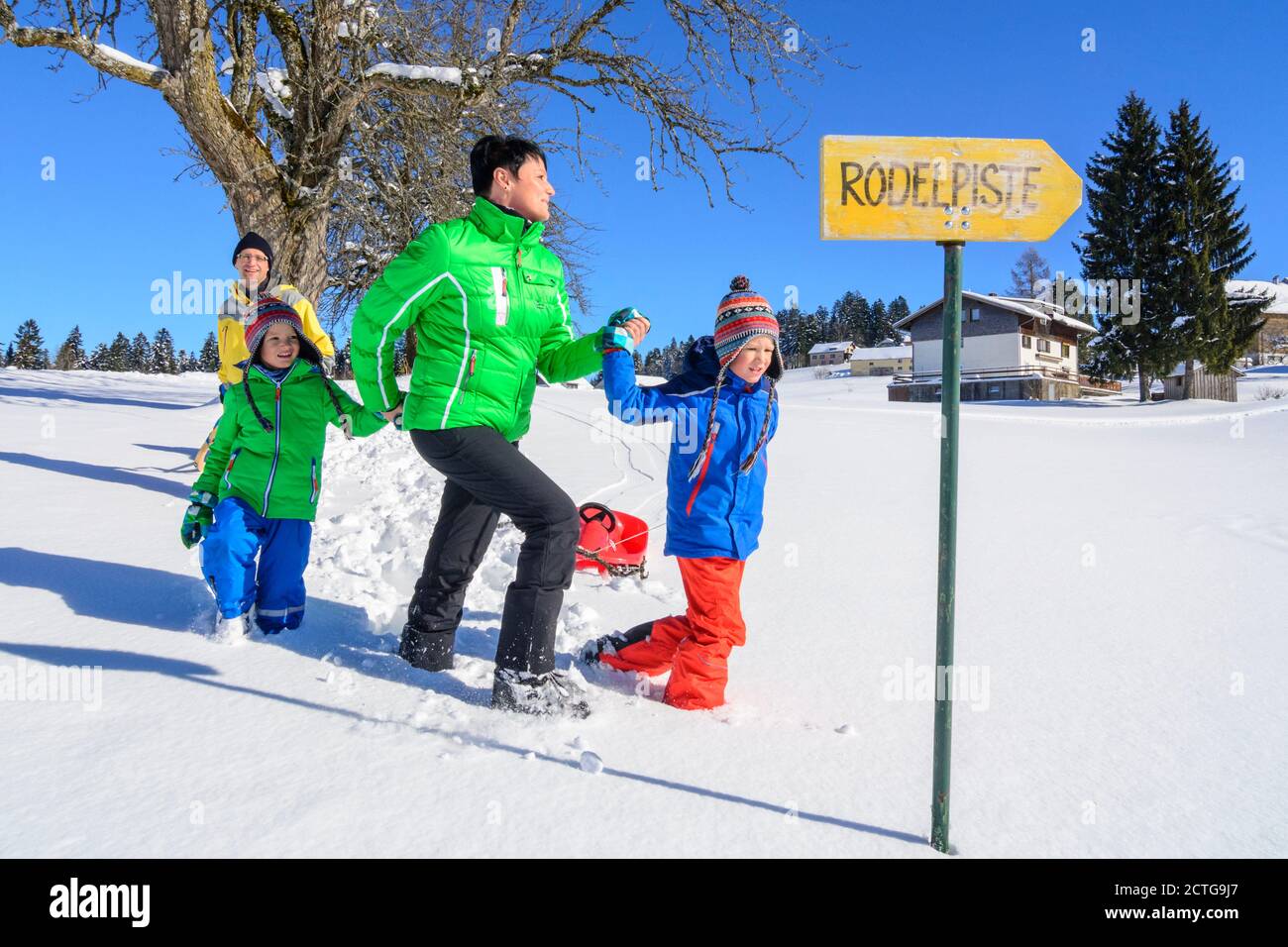 Family ascending to the next sleigh run Stock Photo - Alamy