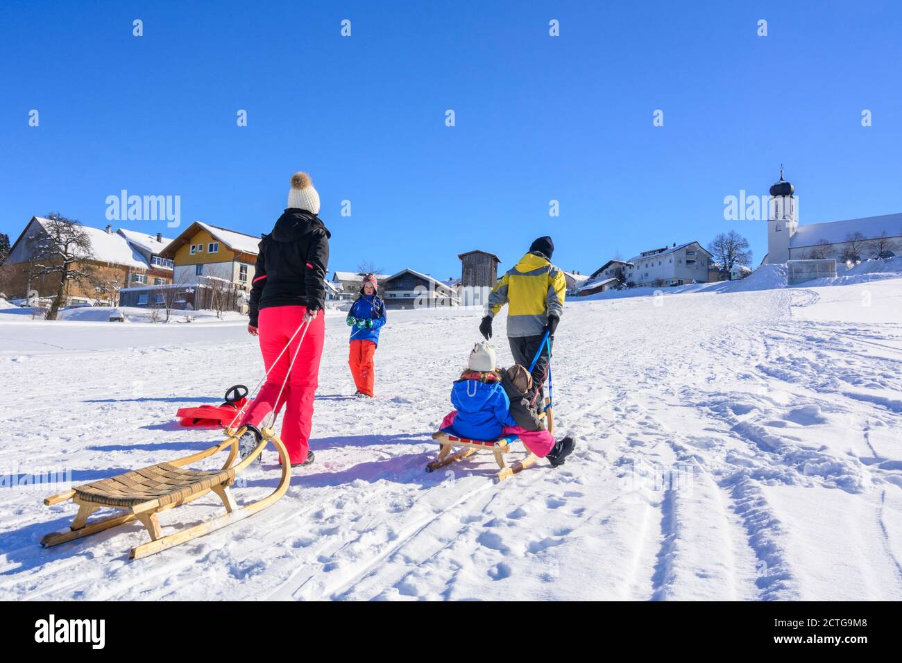 Family ascending to the next sleigh run Stock Photo - Alamy