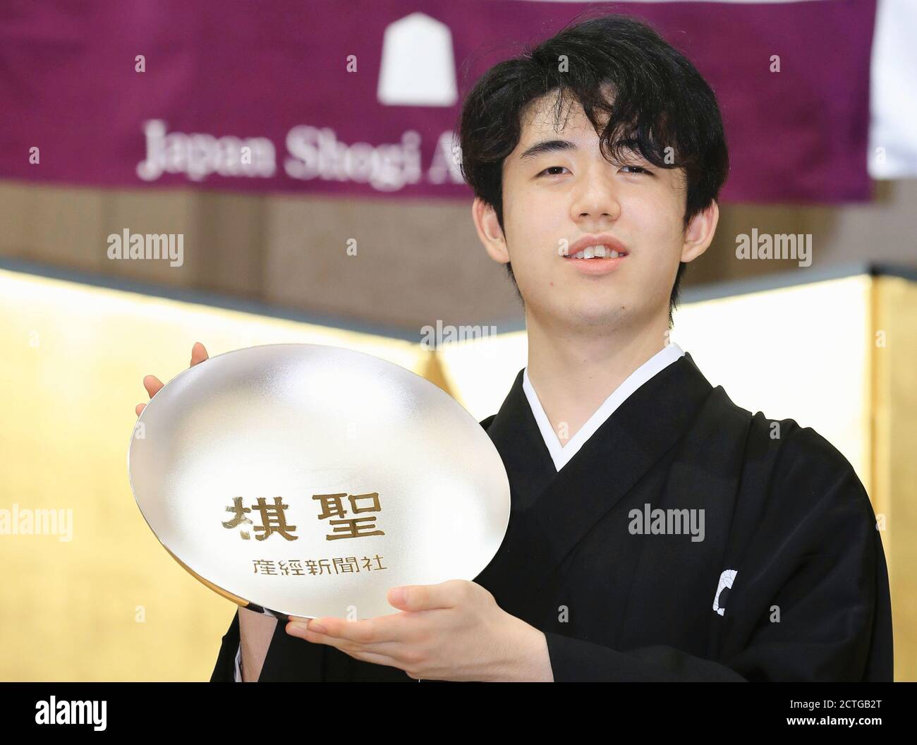 Shogi sensation Sota Fujii holds his prize during a ceremony in Tokyo ...
