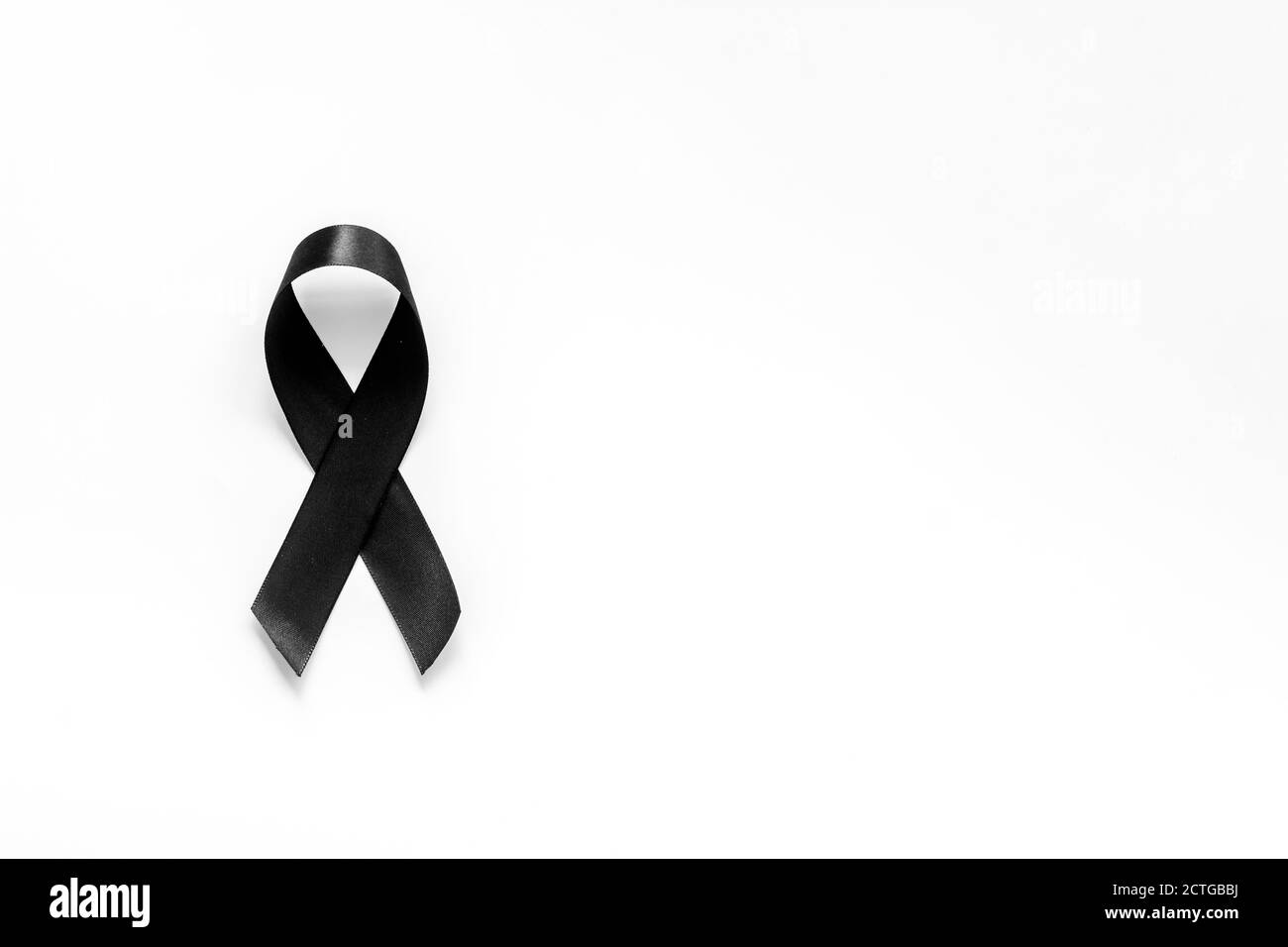 Black ribbon as mourning symbol top view Stock Photo - Alamy