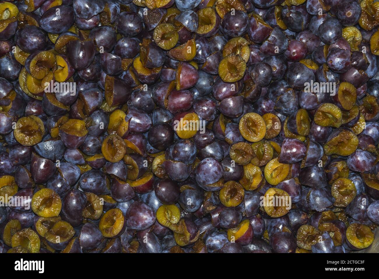 Top view of halved and whole plums with seeds removed Stock Photo - Alamy