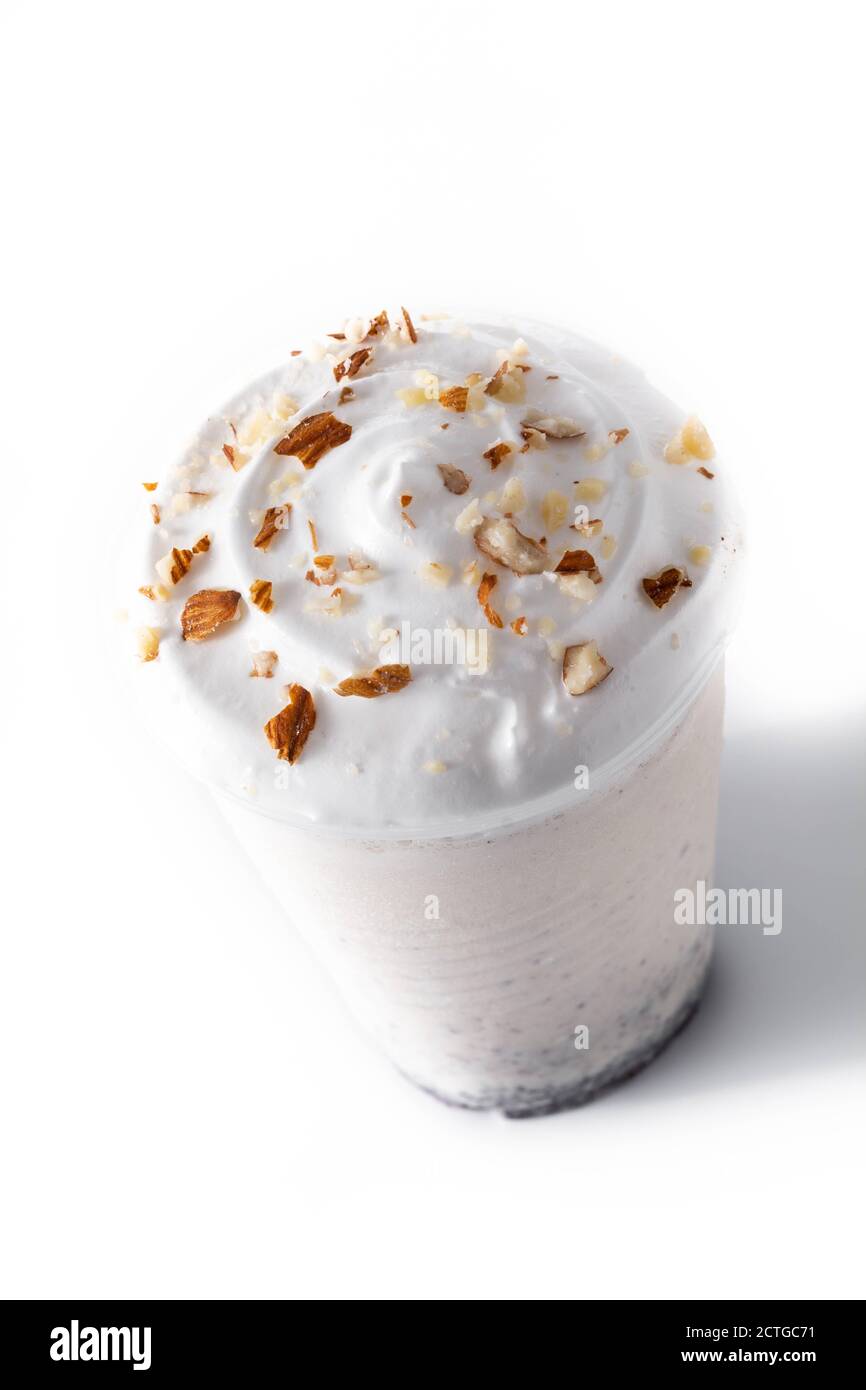 White chocolate, vanilla and nuts iced milkshake isolated on white ...