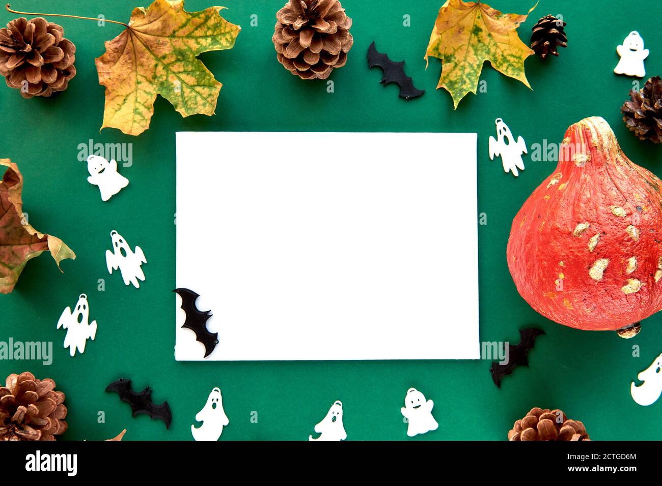 Autumn composition. Pumpkins,dried leaves and decorative ghoasts and ...