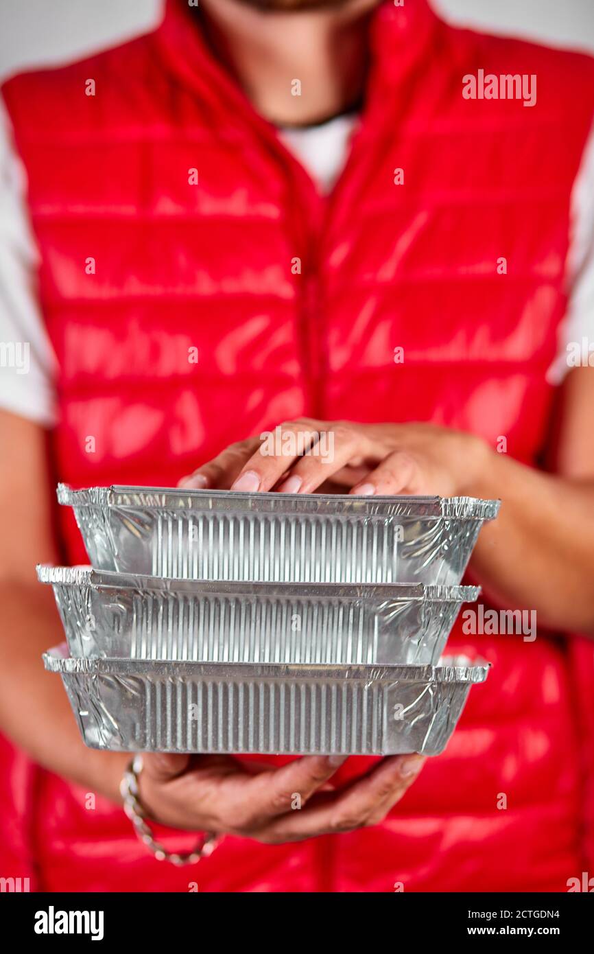 Delivery man in red vest uniform hold go box food, delivery service ...