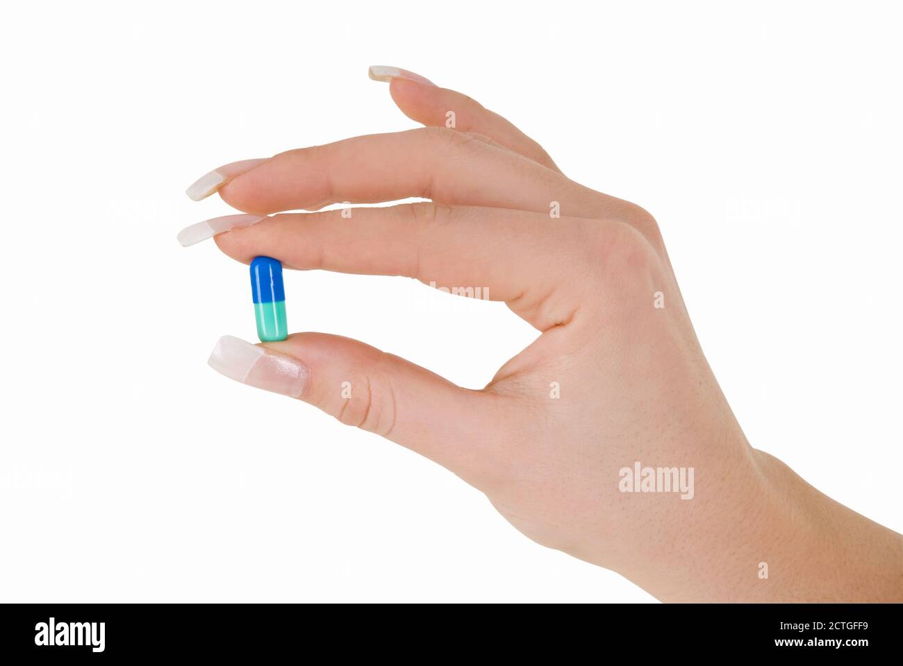 Woman's hand holding a capsule with medicine Stock Photo - Alamy