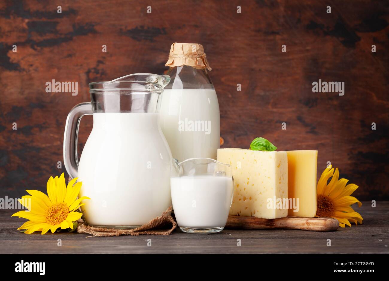 Various dairy products. Milk and cheese. In front of wooden background ...
