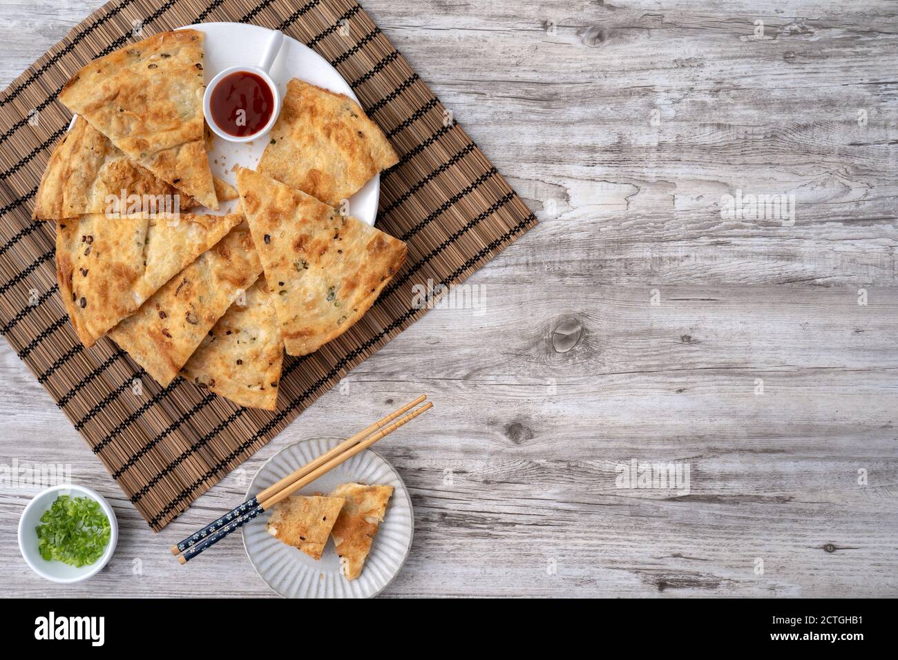 Taiwanese food - delicious flaky scallion pie pancakes on bright wooden ...