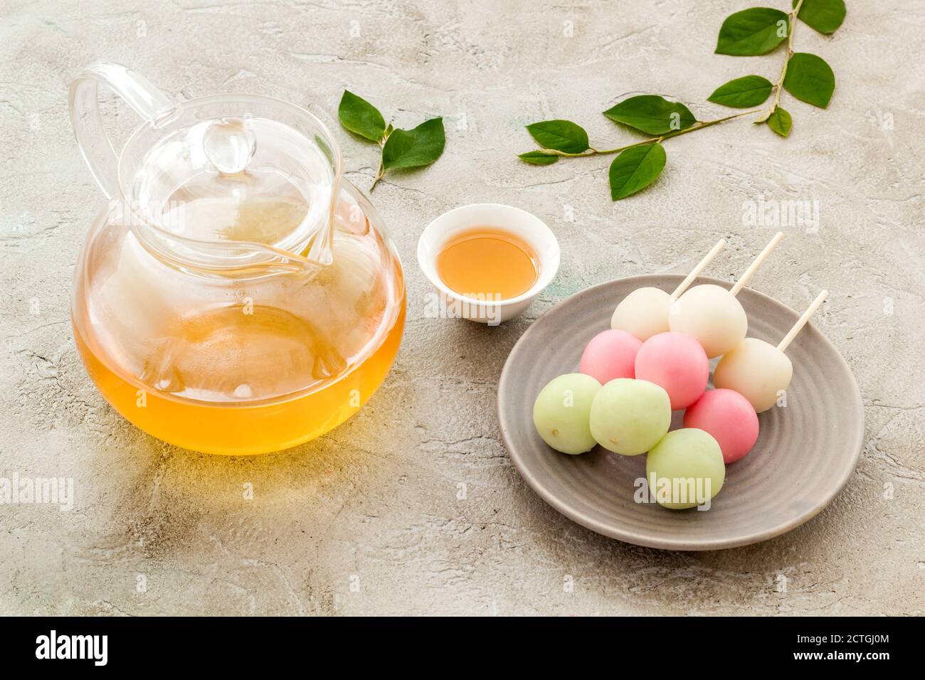 Japanese tea and sweet dumplings Dango on plate, close up Stock Photo ...
