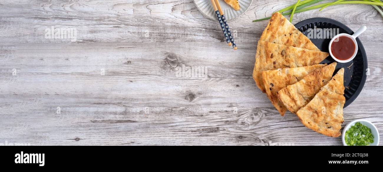 Taiwanese food - delicious flaky scallion pie pancakes on bright wooden ...