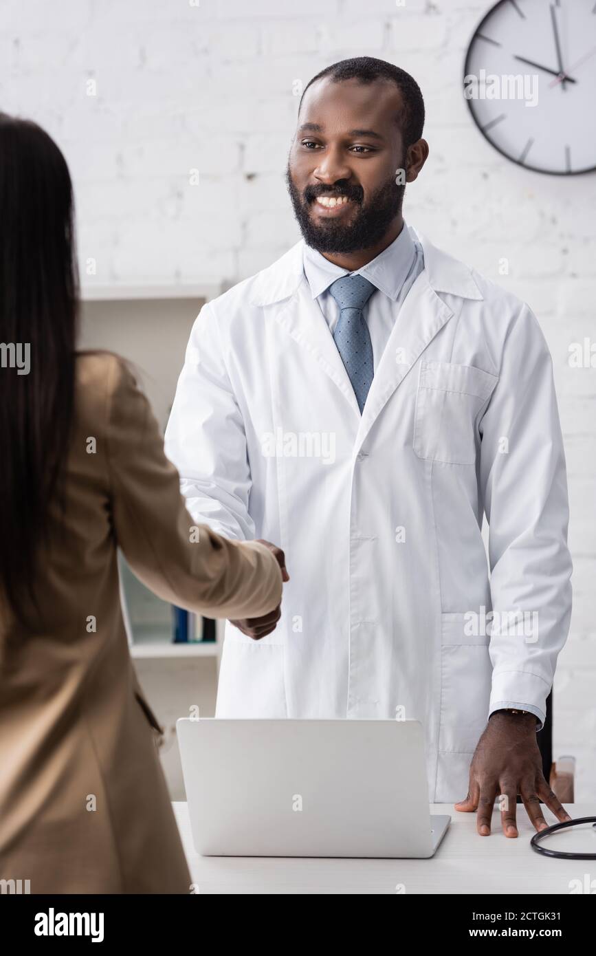 Selective focus of african american doctor standing and looking at ...