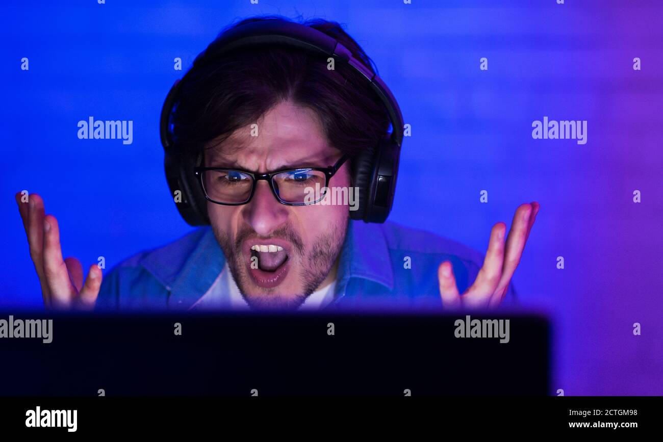 Gamer Shouting And Gesturing Having Low Internet Sitting Indoor, Low ...