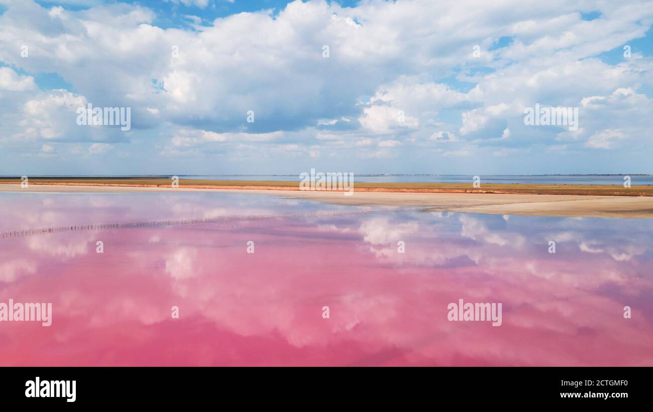Aerial view of colorful pink salt lake and clouds reflection. Genichesk ...
