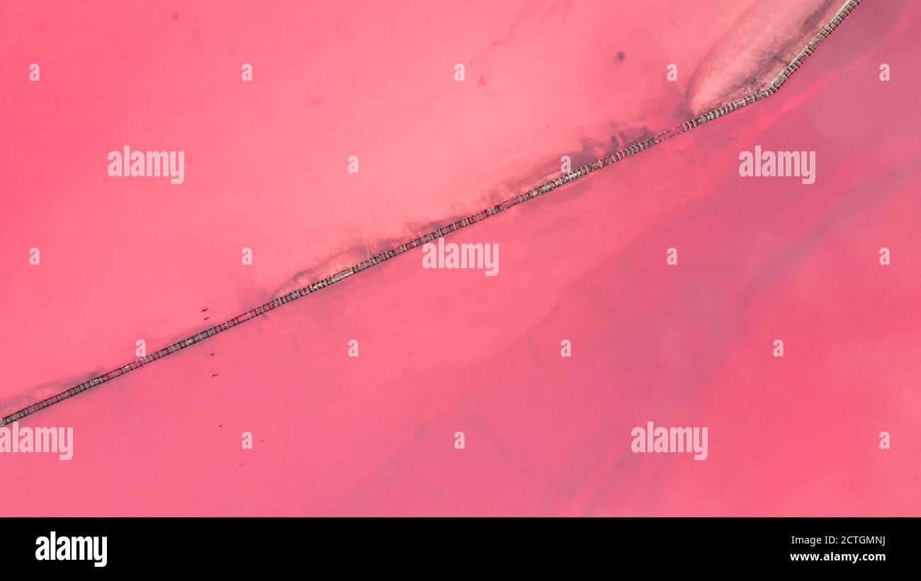 Aerial view of wooden structures for collecting salt on a pink lake ...