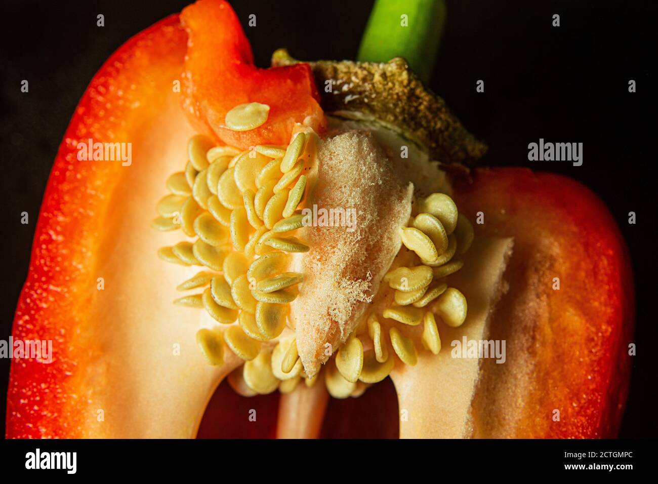 Red bell pepper cut open showing seeds Stock Photo - Alamy