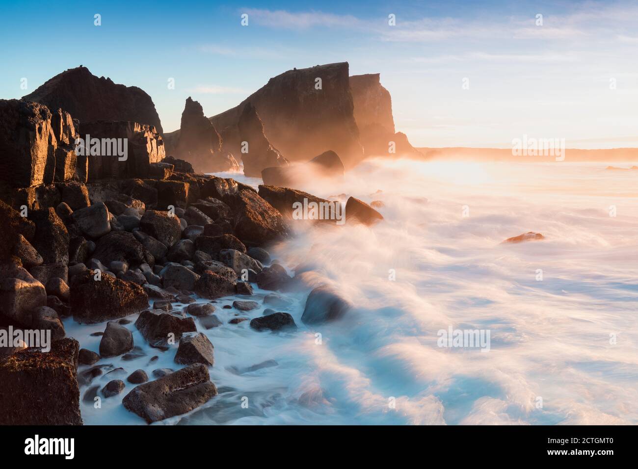 Rugged Icelandic coastline with big waves hitting the black rocks in ...