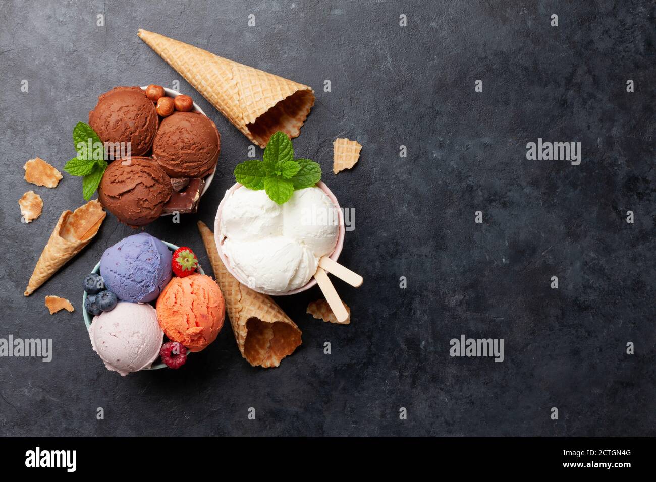 Berry, vanilla and chocolate ice cream sundae. Top view flat lay with ...