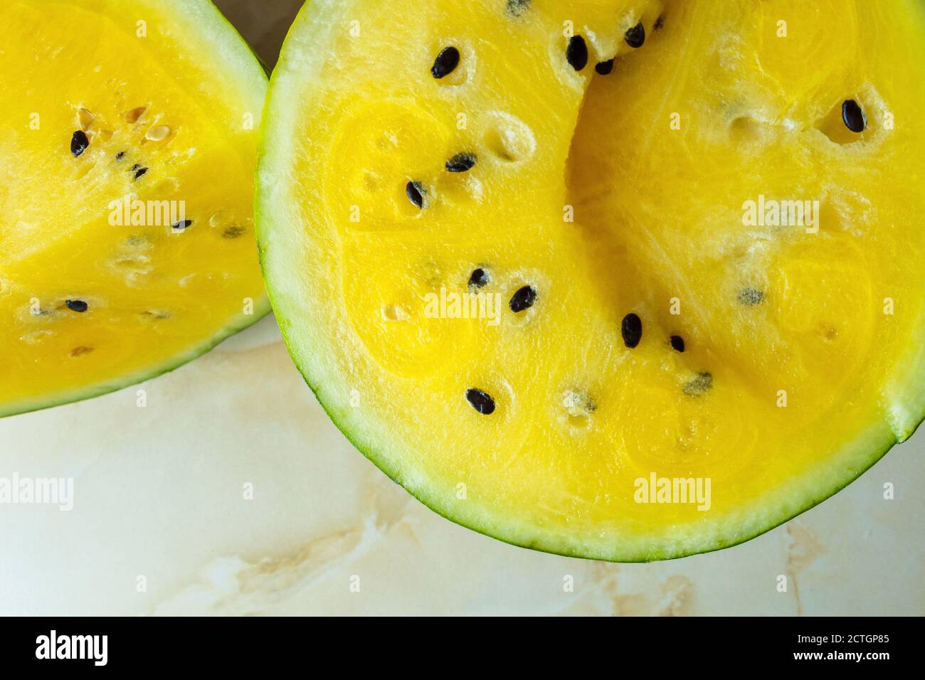 Watermelon with yellow pulp, cut in half. Two halves of a yellow ...