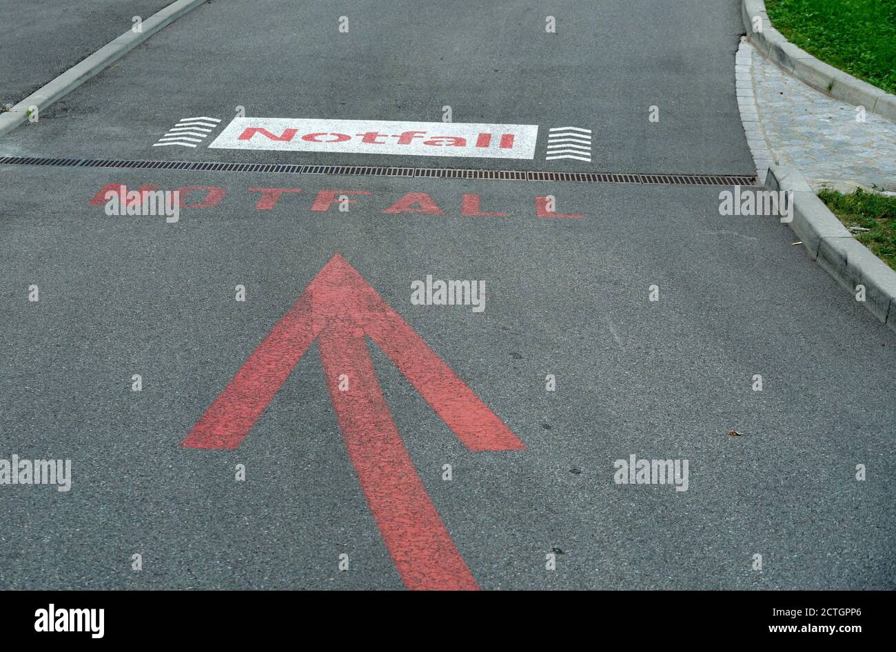 Two signs on the street or asphalt road written in German language and ...