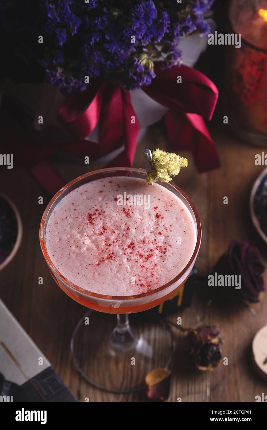 Berry red alcoholic sour cocktail in dark style Stock Photo - Alamy