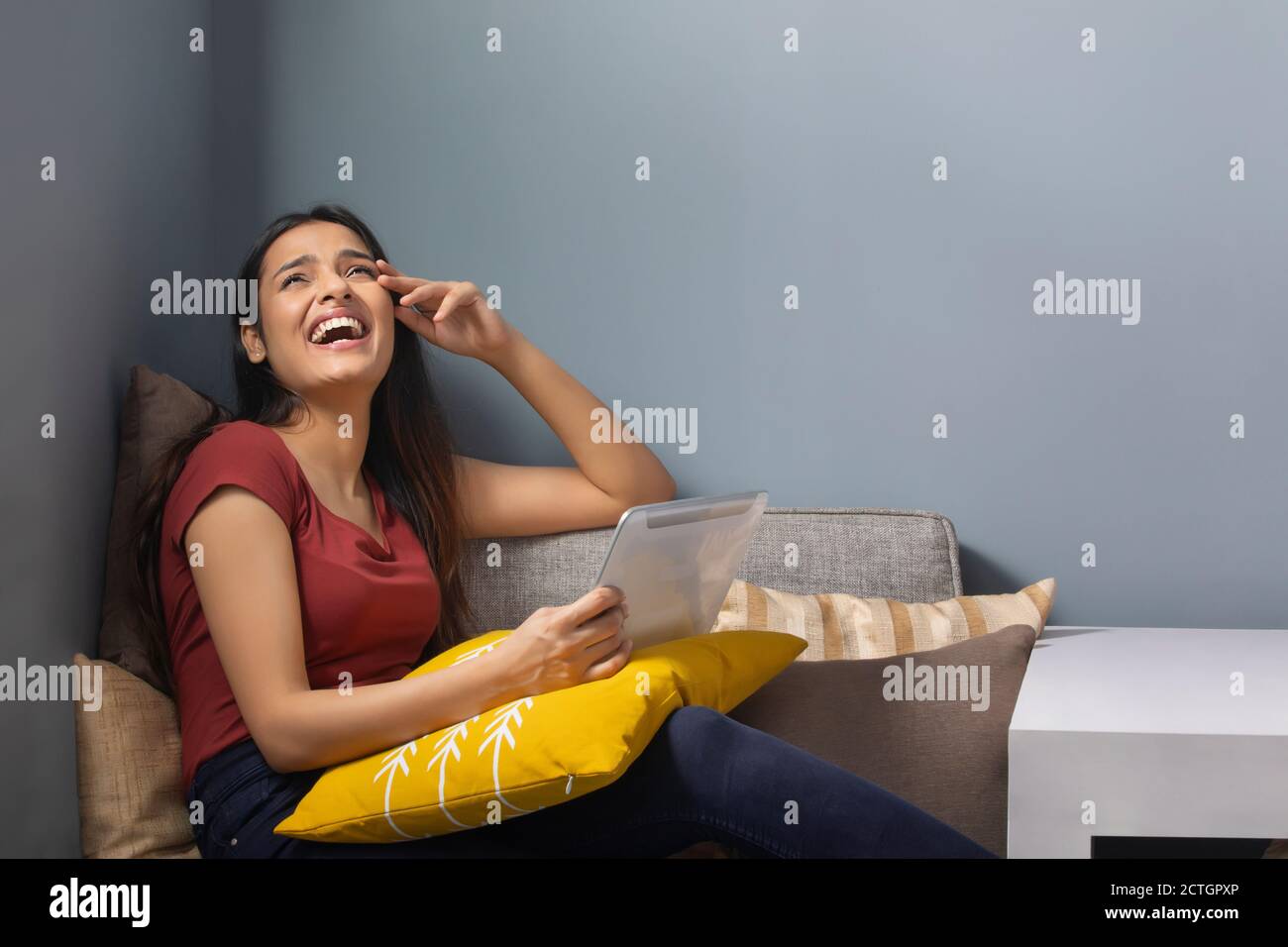 Beautiful woman laughing while talking on video call Stock Photo - Alamy