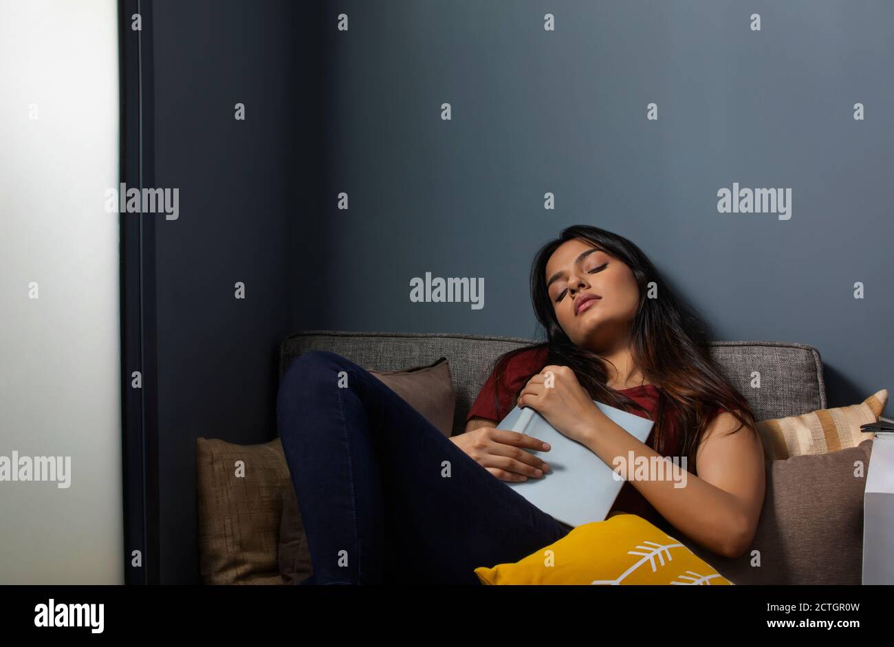 Young woman sleeping while reading a book Stock Photo - Alamy