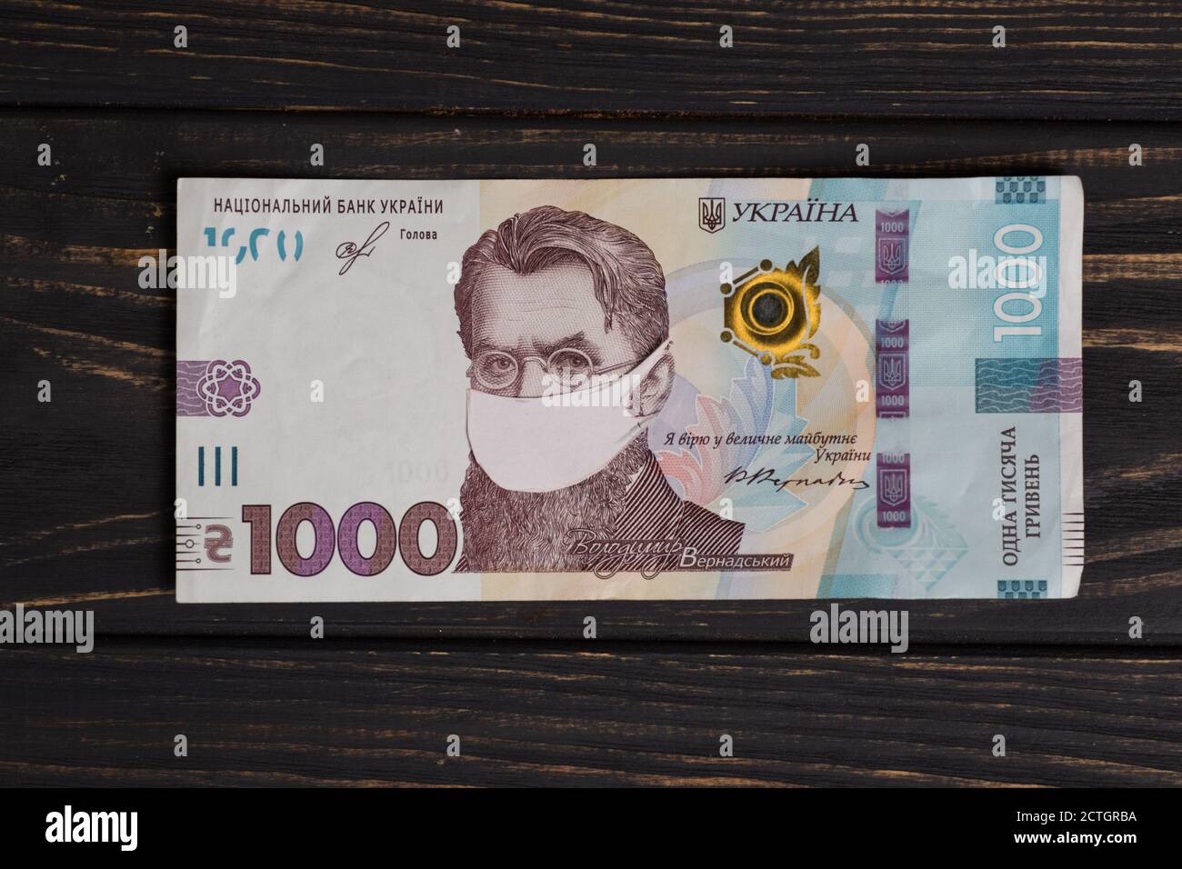 Coronovirus crisis concept - money of Ukraine with protective mask ...