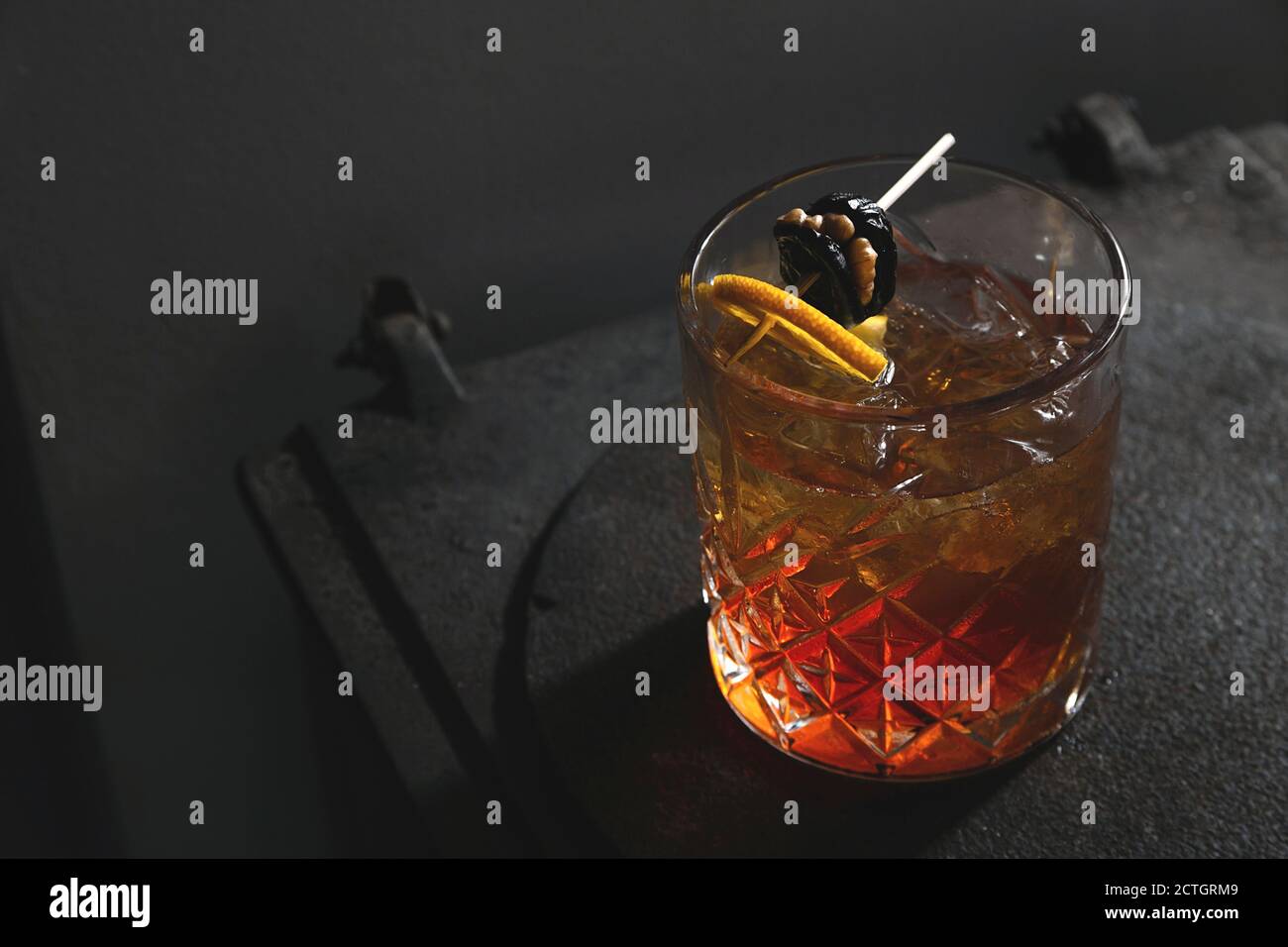 Male red alcoholic cocktail with walnut and prunes Stock Photo - Alamy
