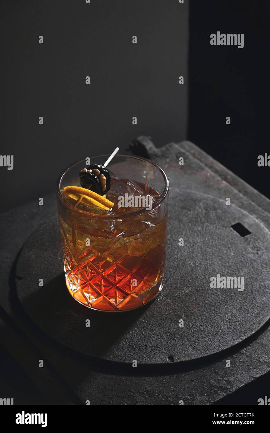 Male red alcoholic cocktail with walnut and prunes Stock Photo - Alamy