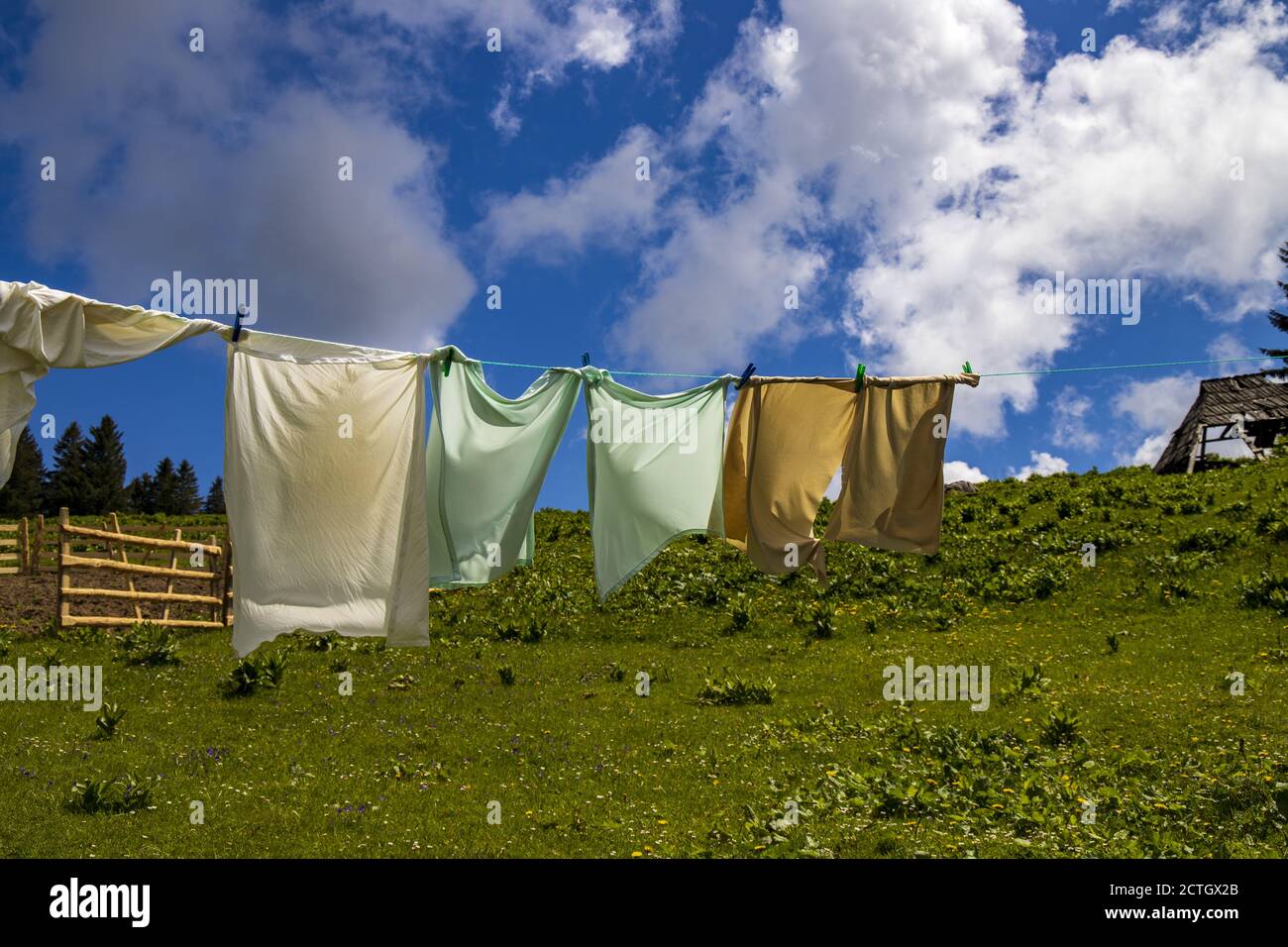 Clothes drying on a laundry cable under a cloudy sky Stock Photo - Alamy