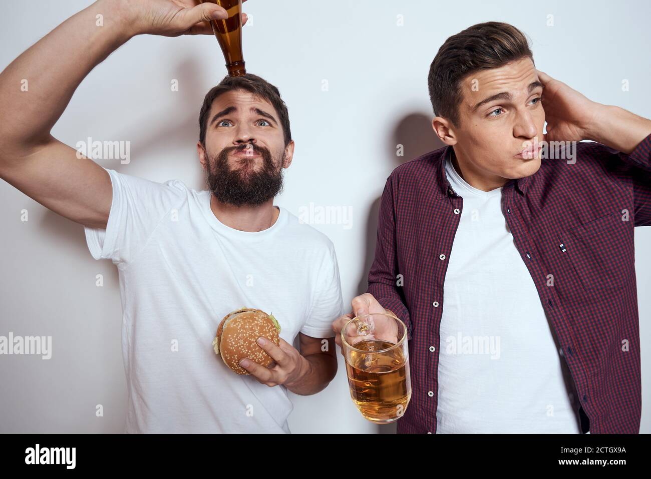 Two friends drink beer leisure fun alcohol friendship lifestyle light ...