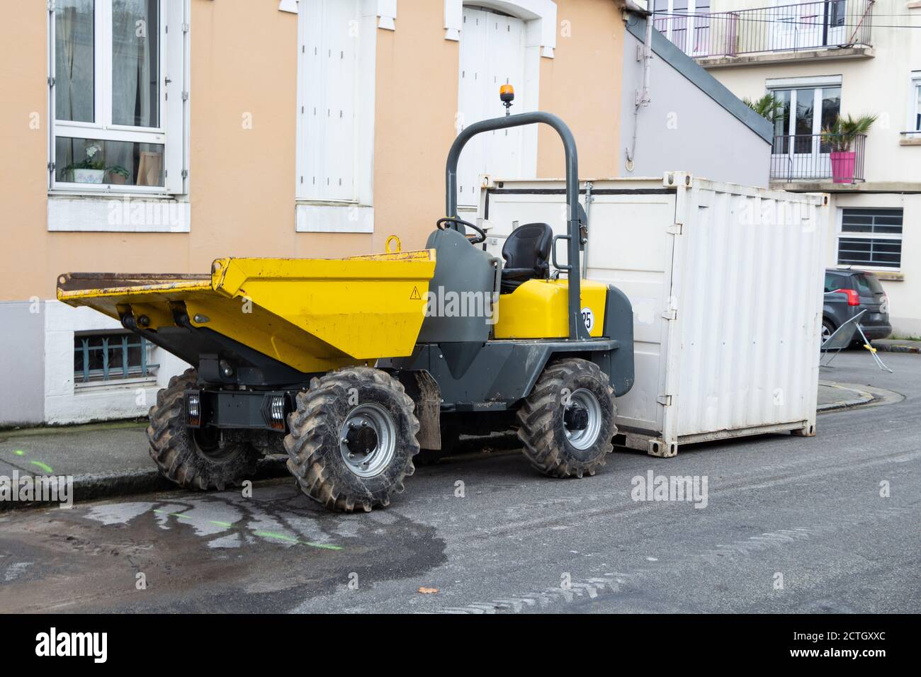 Dumper and container for a construction site in a street Stock Photo ...