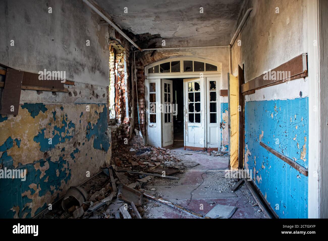 corridor with beautiful doors in an old abandoned building Stock Photo ...