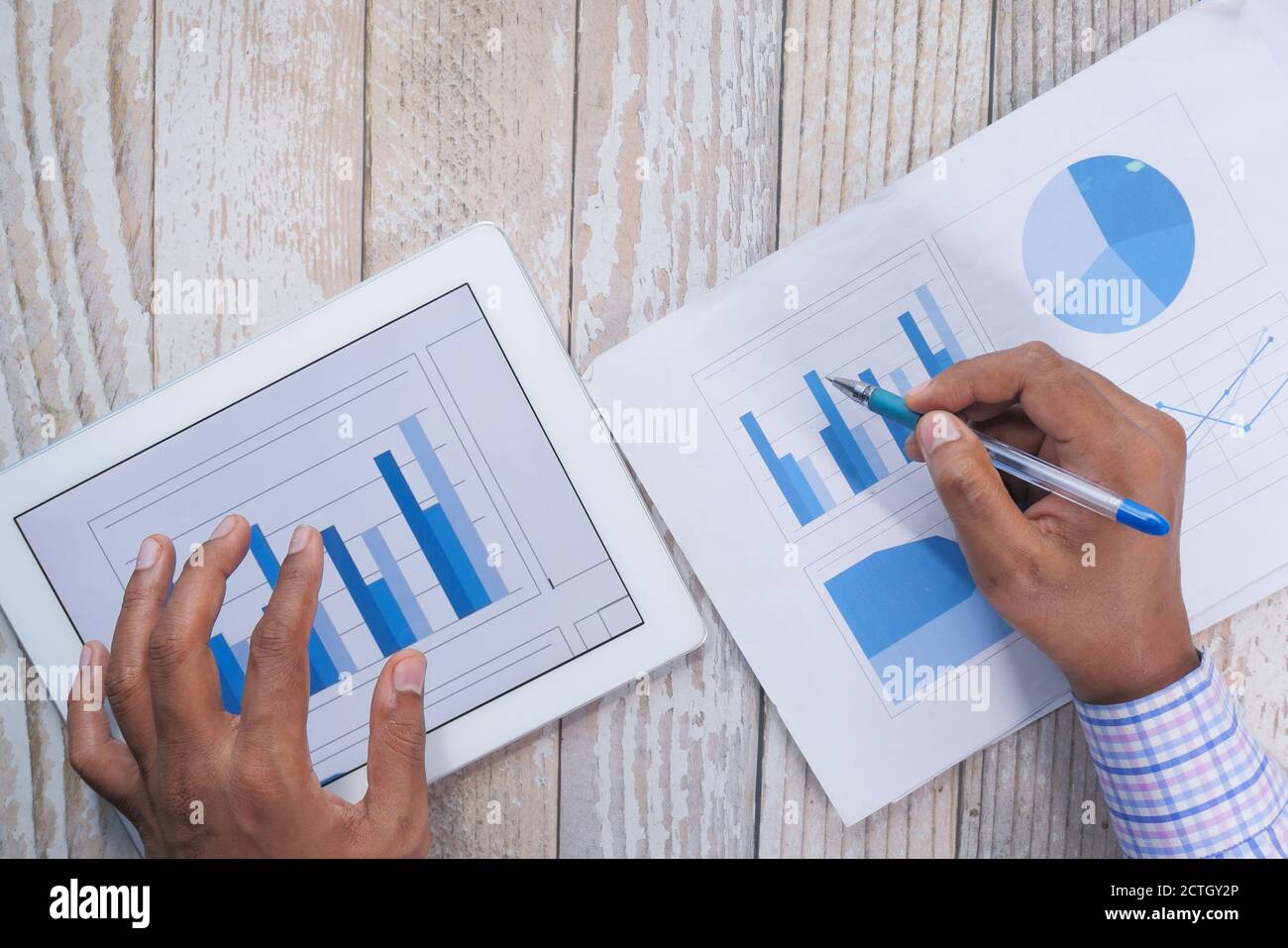 man's hand working on digital tablet at office desk, using self created ...