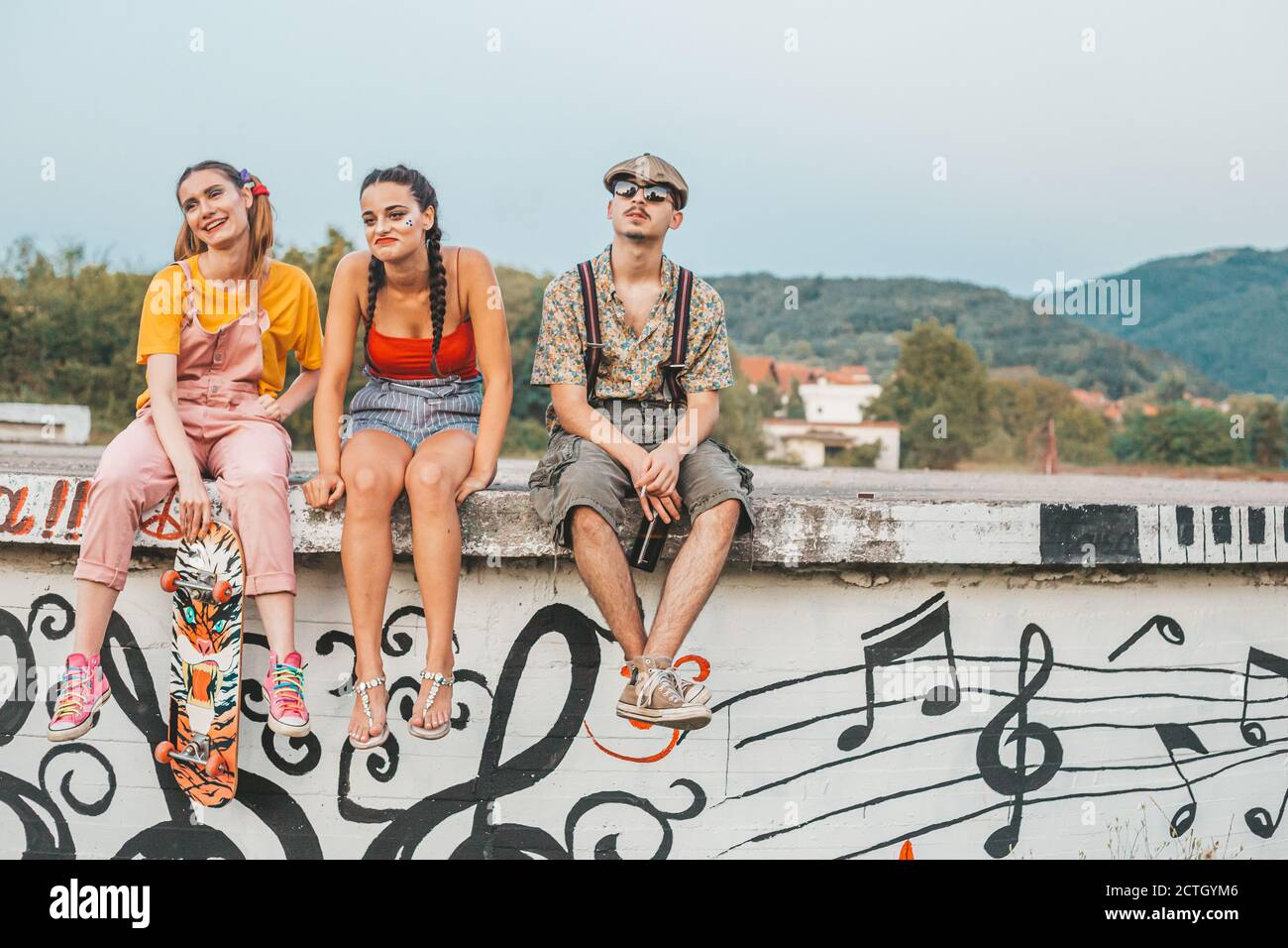 Group of friends hanging out outside. Chilling Stock Photo - Alamy