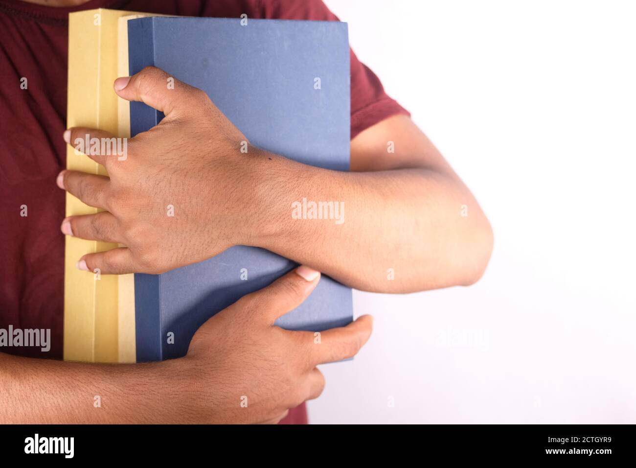 hand holding stack of books on color background Stock Photo - Alamy