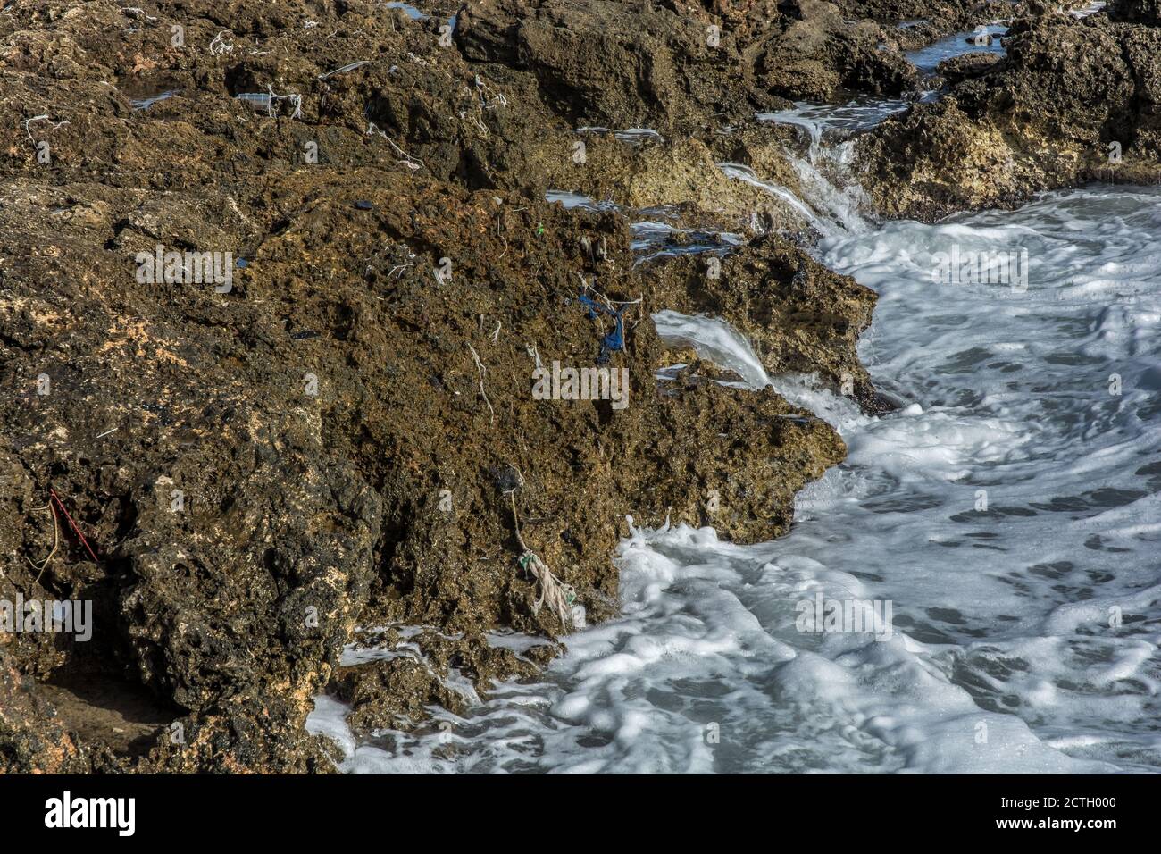 Plastic waste is washed up on dirty coast Stock Photo - Alamy