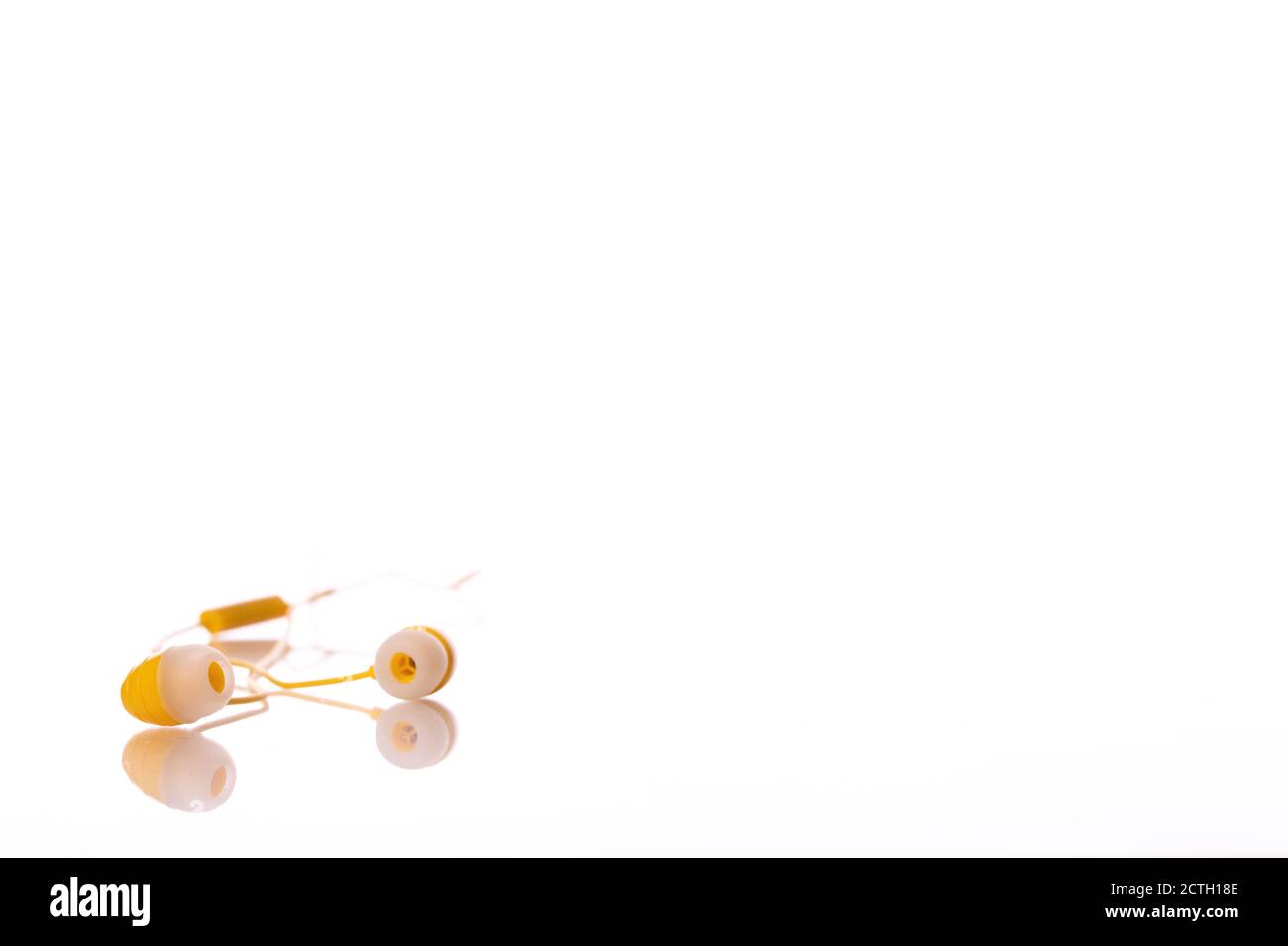 small yellow color earphone isolated on white background copy space ...