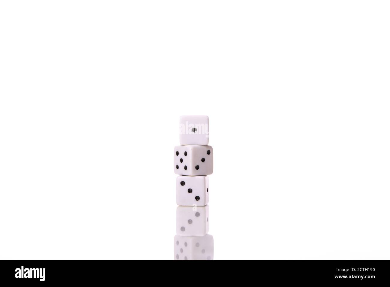 end to end Stack of three white dice black pips reflected in table ...