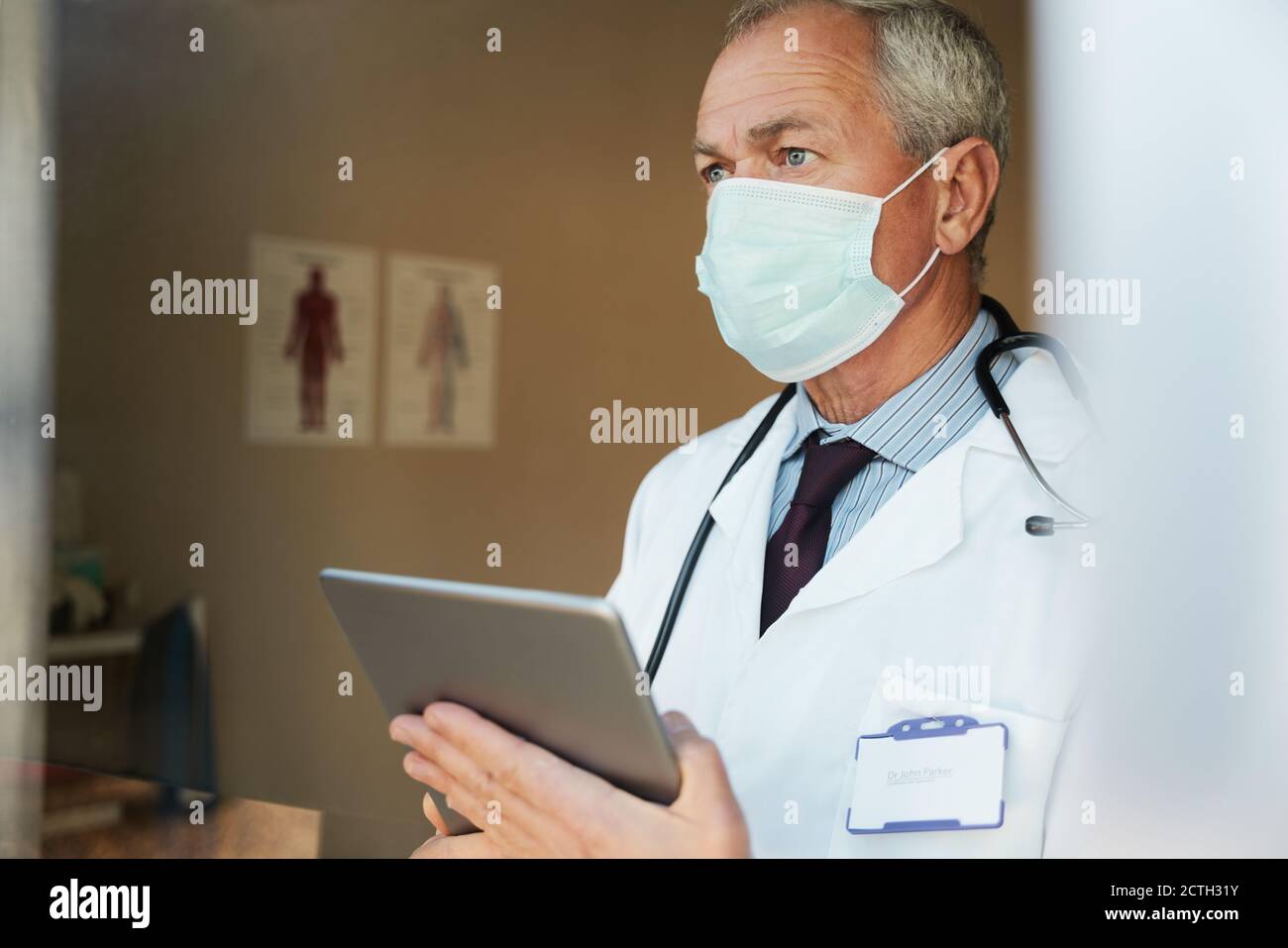 Doctor male standing wearing hi-res stock photography and images - Alamy