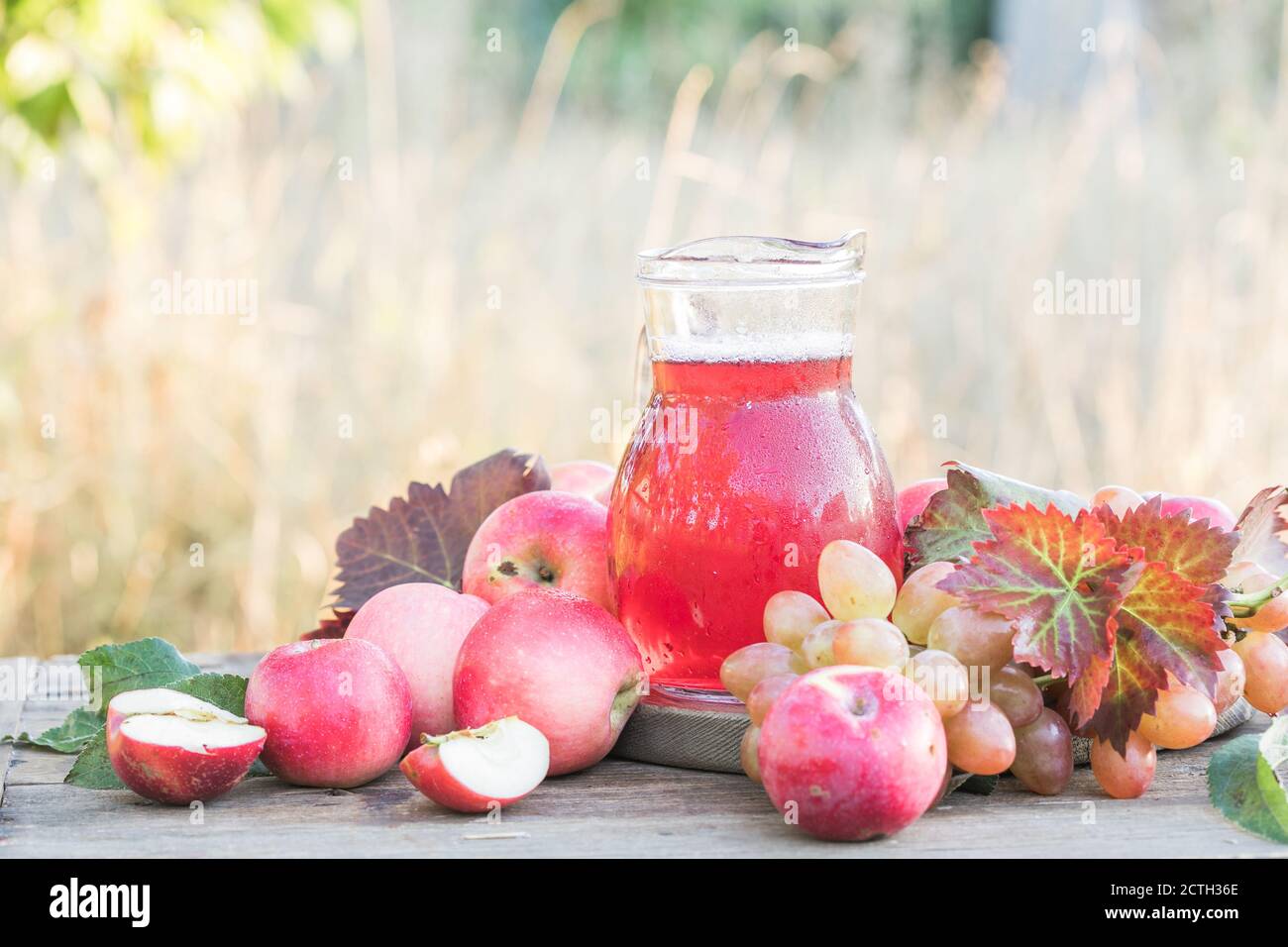 Homemade Apple Cider or Juice or Grape beverage on Wooden Background ...